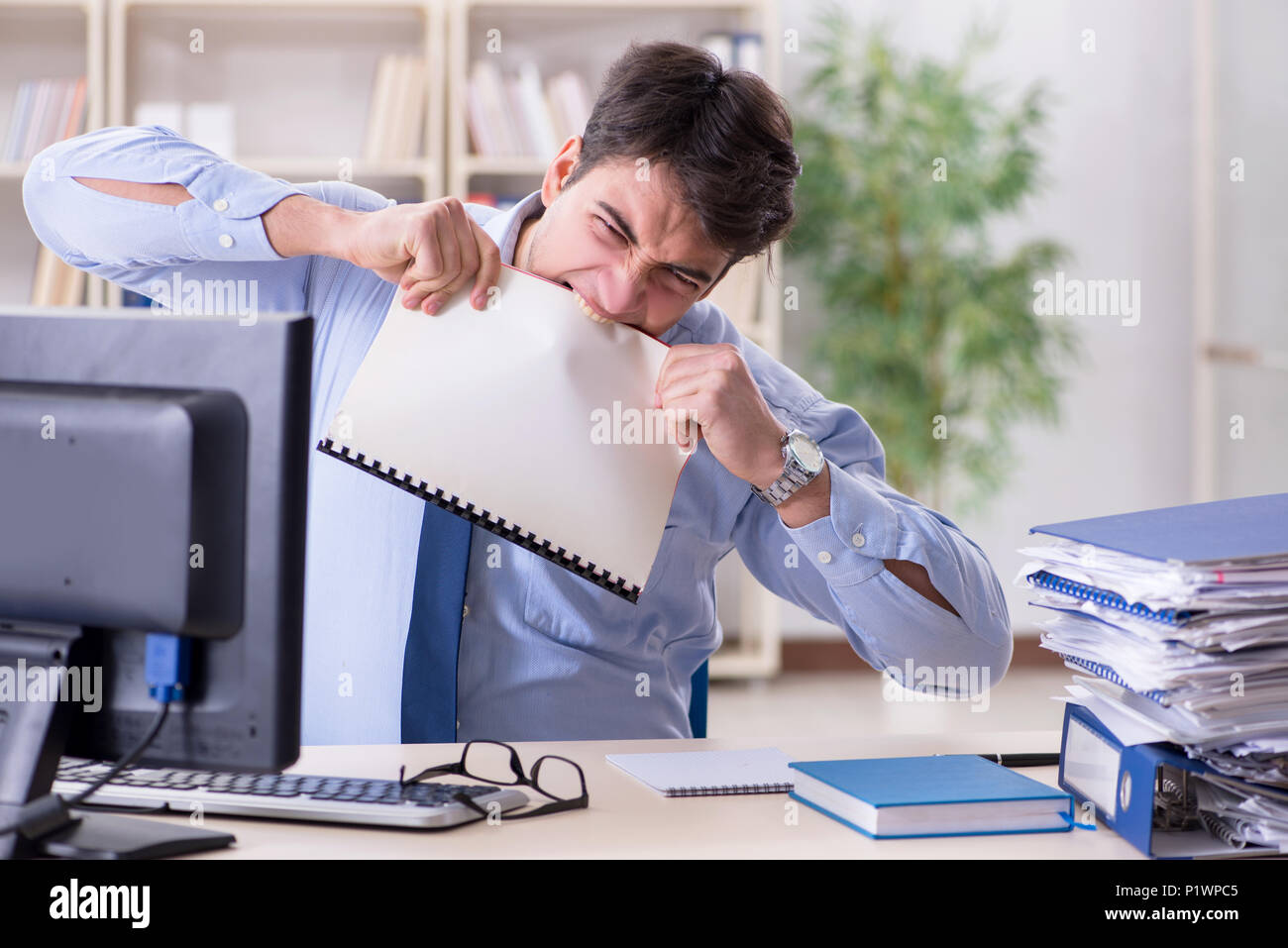 Tired businessman with too much paperwork Stock Photo - Alamy
