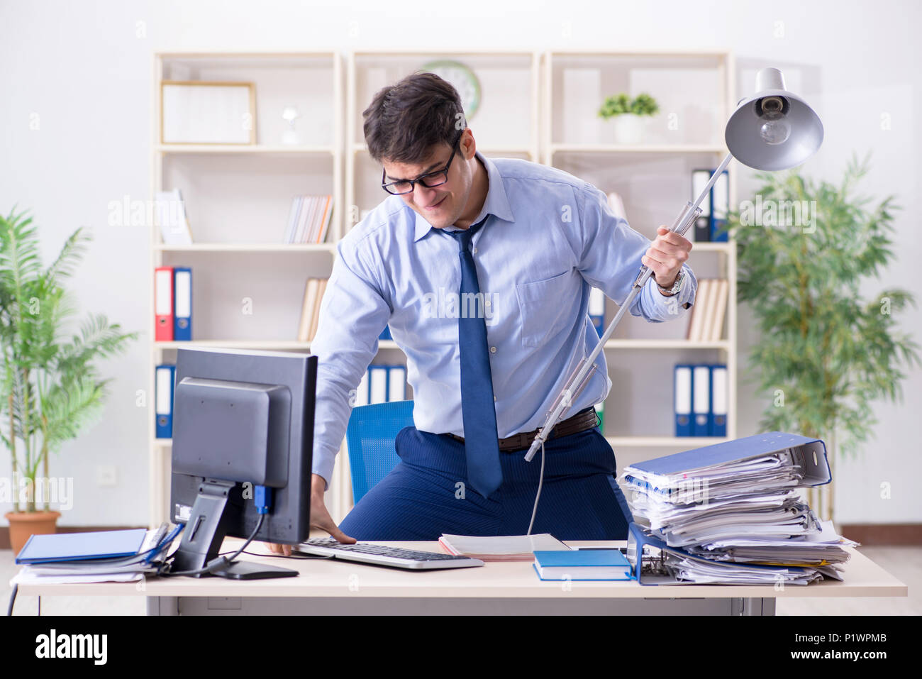 Angry businessman frustrated with too much work Stock Photo - Alamy
