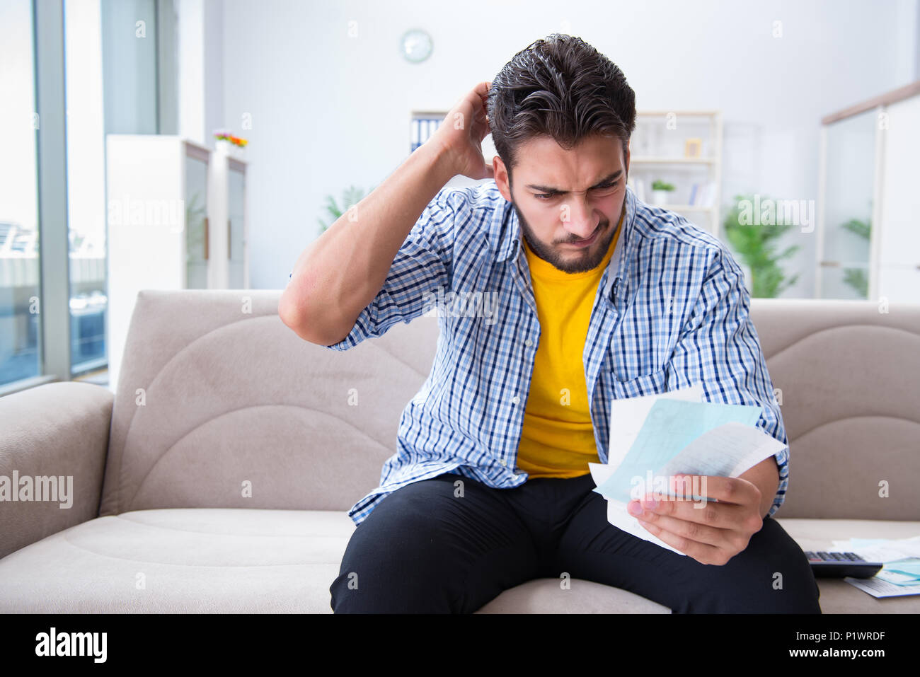 Man angry at bills he needs to pay Stock Photo - Alamy