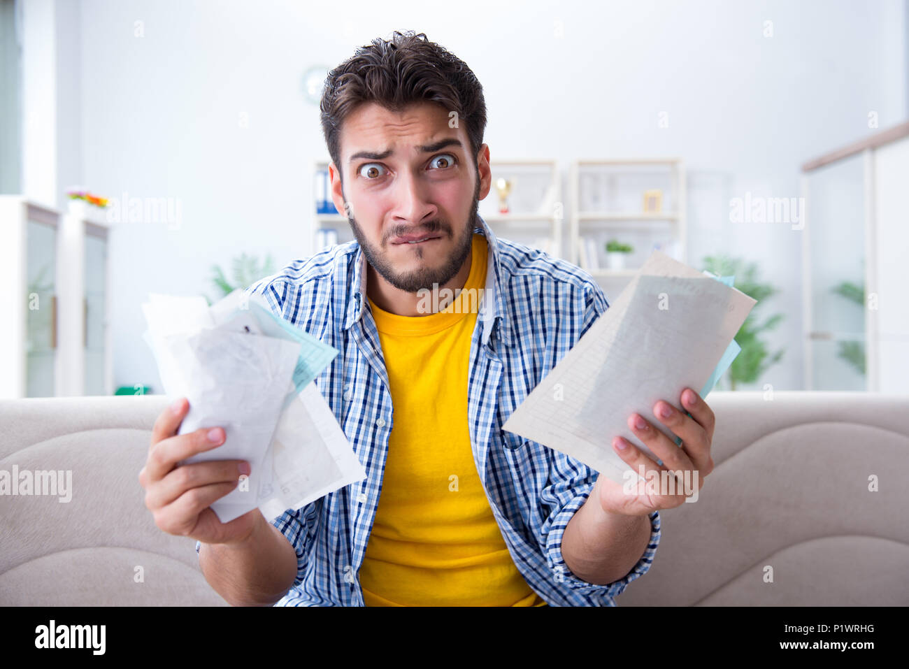 Man angry at bills he needs to pay Stock Photo - Alamy
