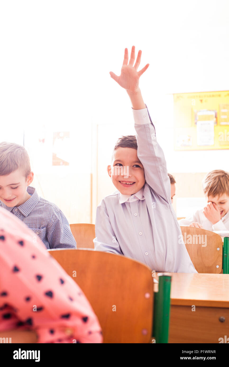 Active boy wants to give an answer Stock Photo - Alamy
