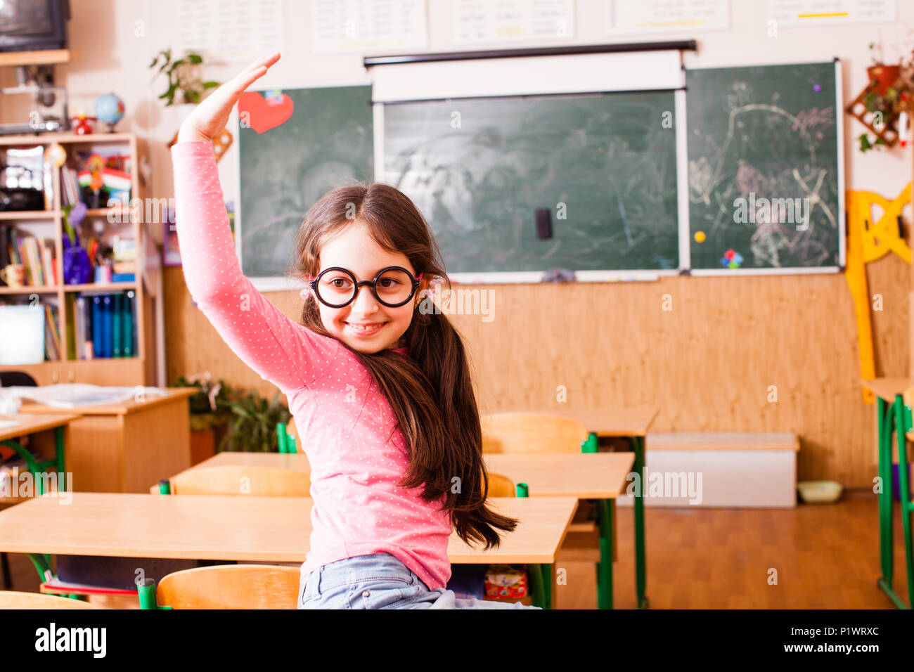 Happy smart girl in classroom Stock Photo - Alamy