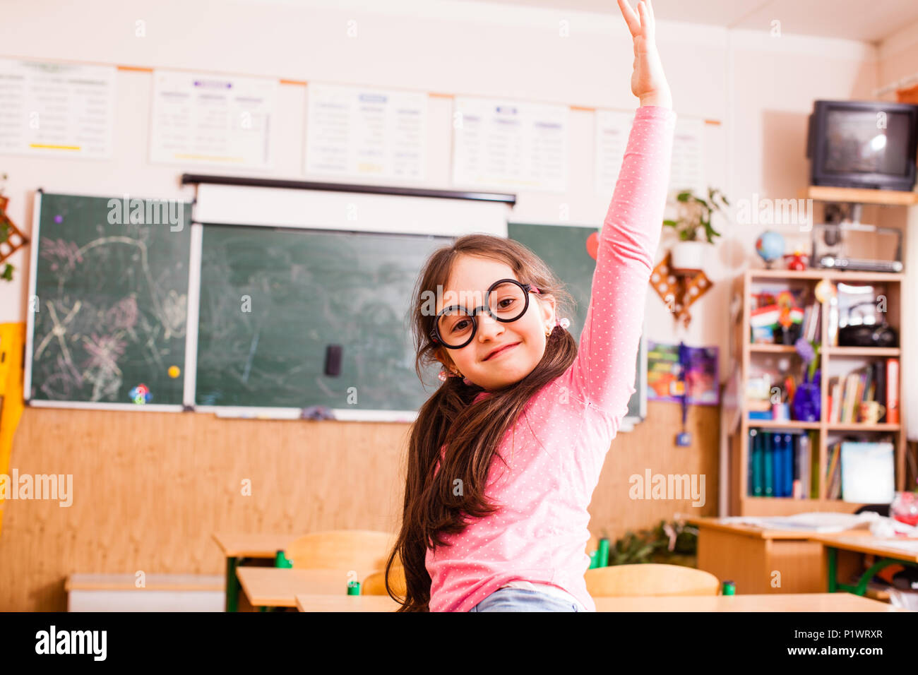 Happy smart girl in classroom Stock Photo - Alamy
