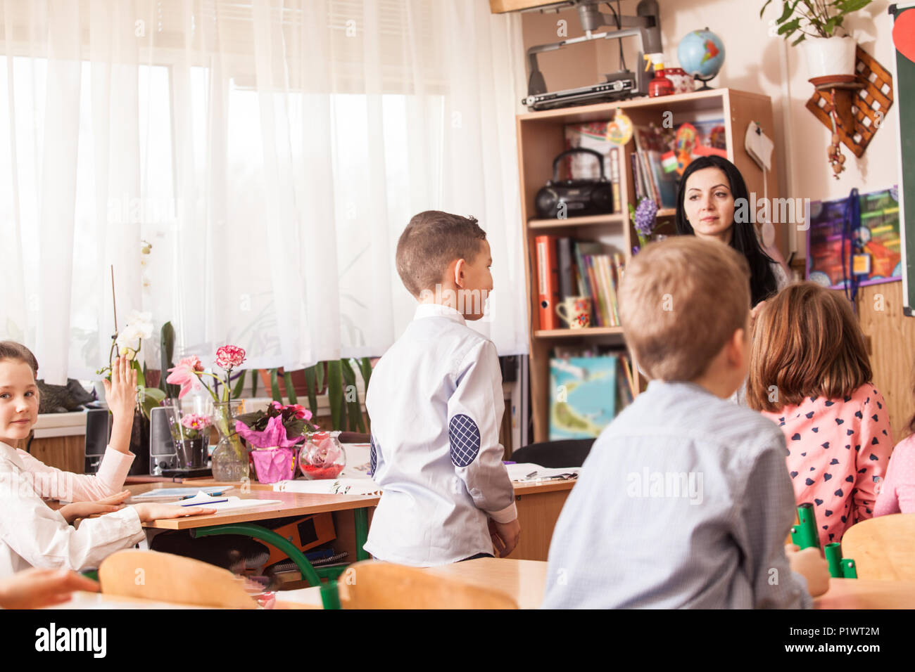 Active boy wants to give an answer Stock Photo - Alamy