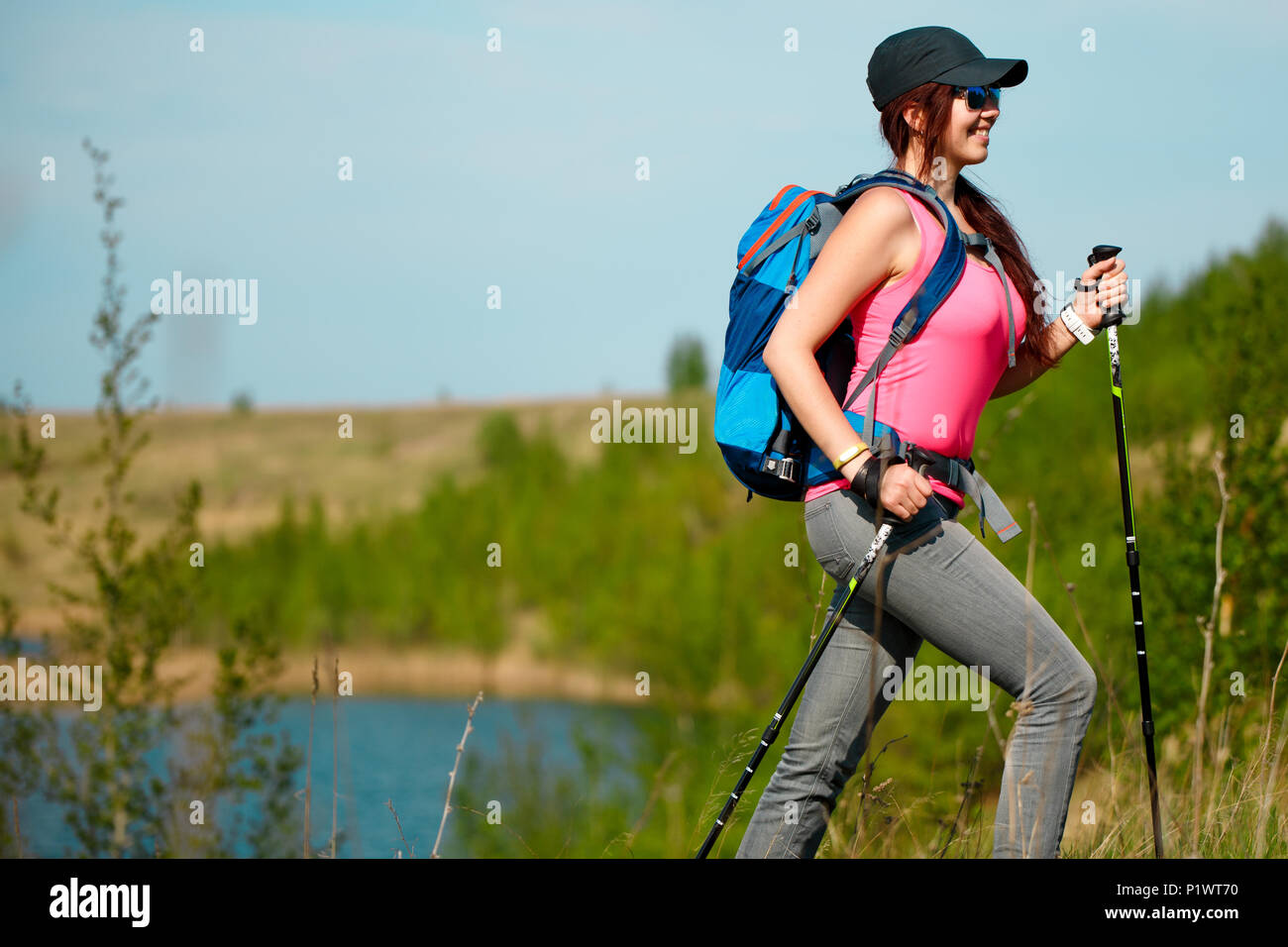 Photo of side view of young sports girl with walking sticks on ...