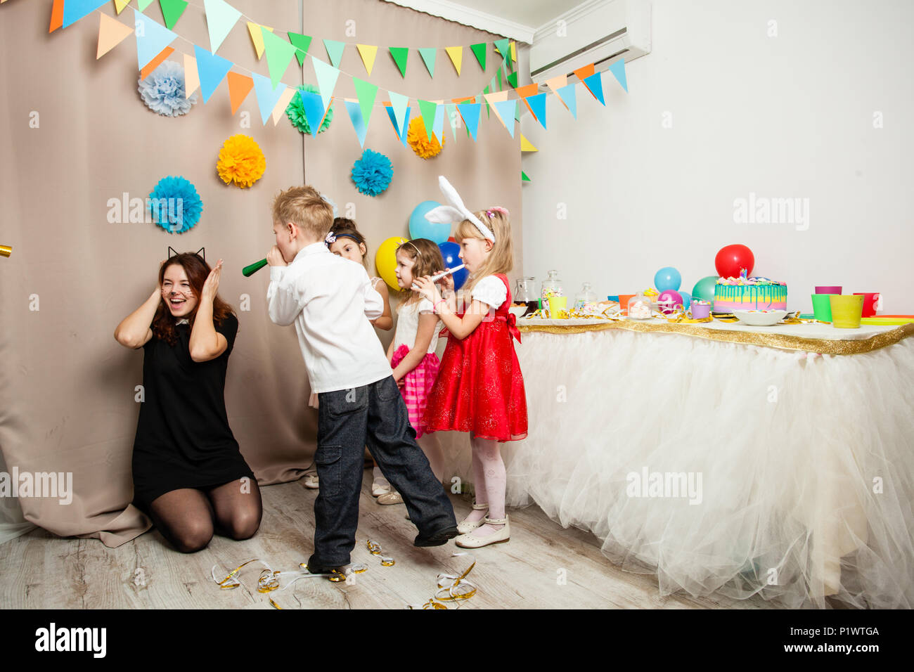 Animator is playing with screaming kids on the birthday party Stock ...