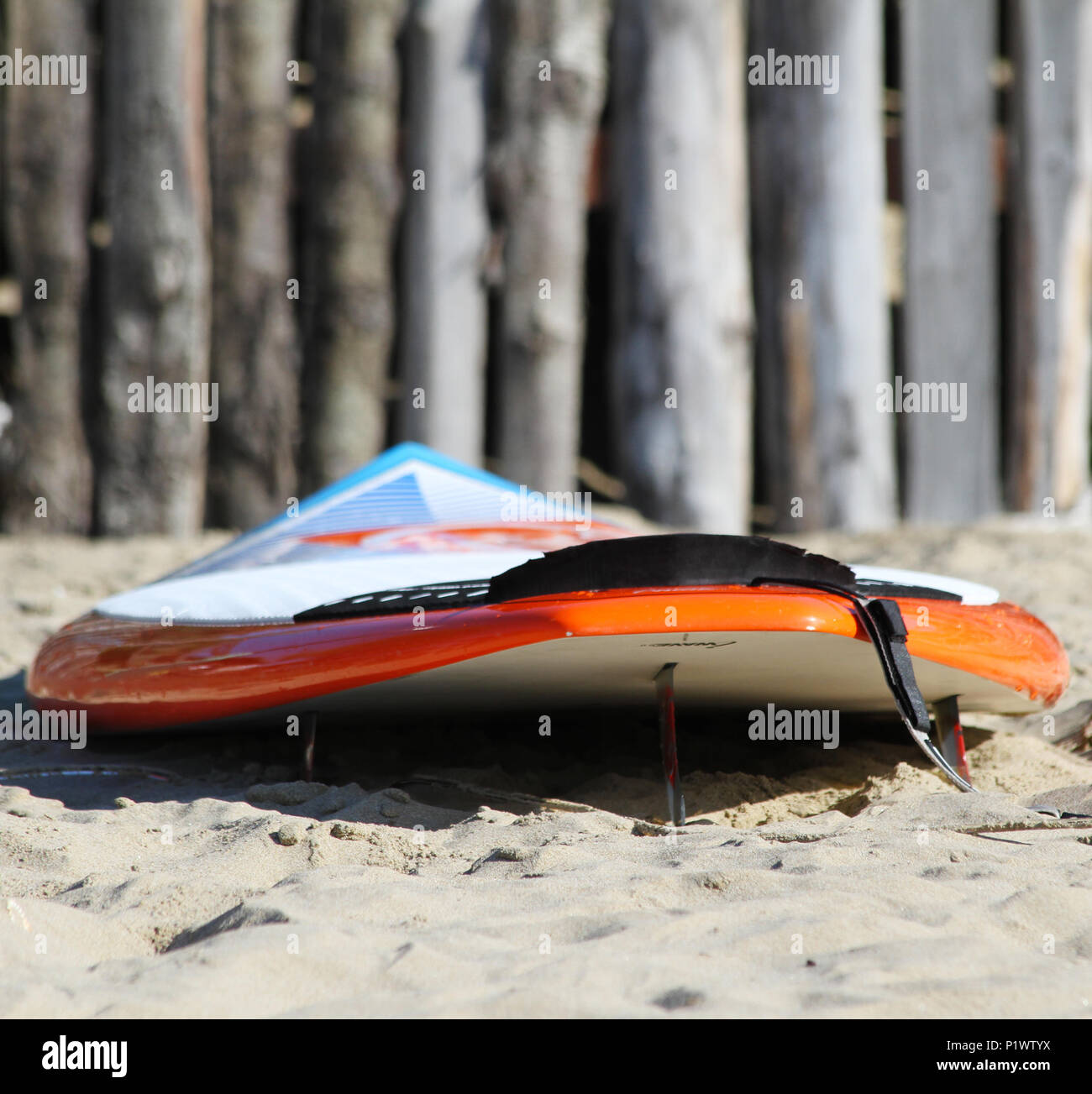 Surf board on the beach. The colourful surf board on wood background ...