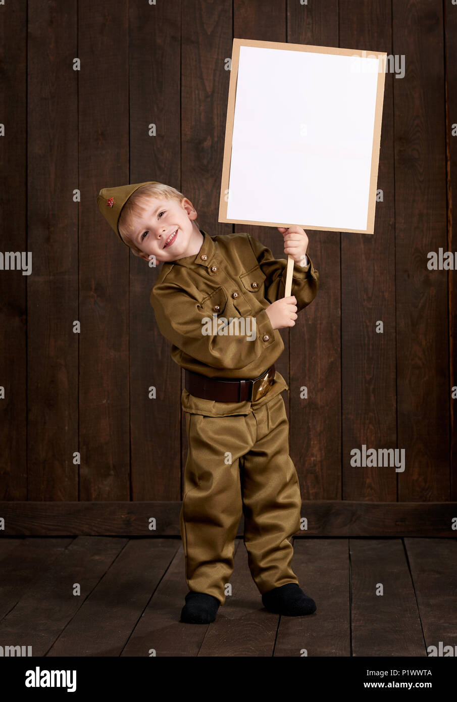 Children boy are dressed as soldier in retro military uniforms. He ...