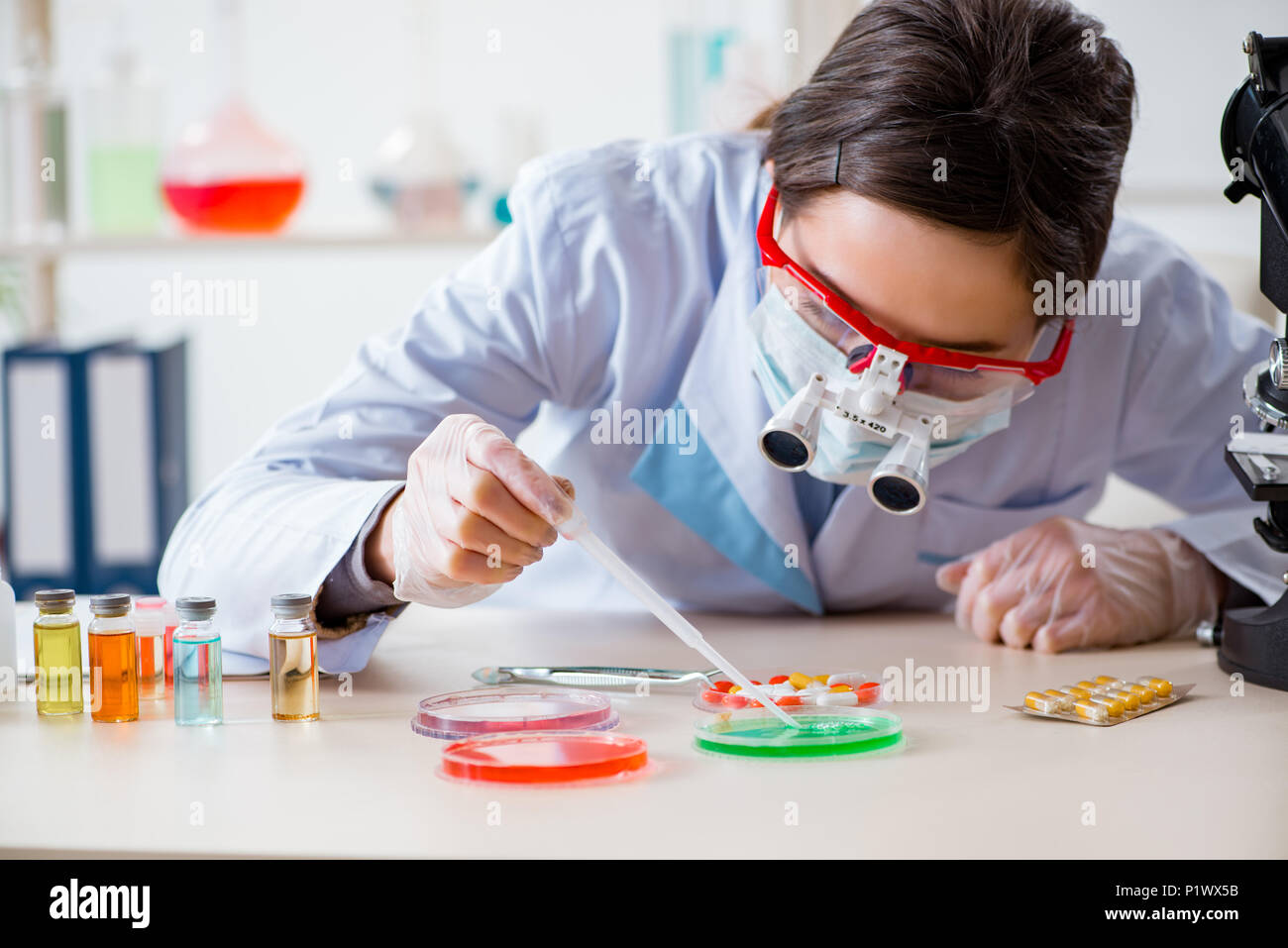 Lab assistant in drug synthesis concept Stock Photo - Alamy