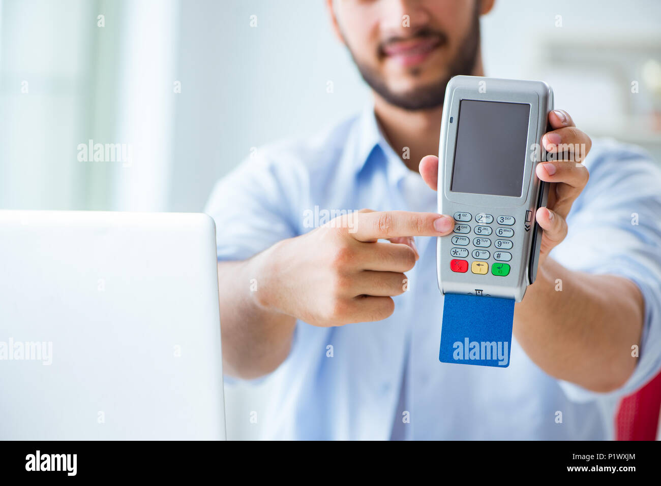 Man processing credit card transaction with POS terminal Stock Photo ...