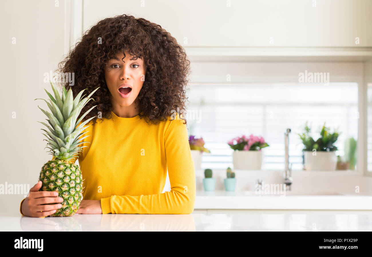 African american woman and pineapple tropical fruit scared in shock ...