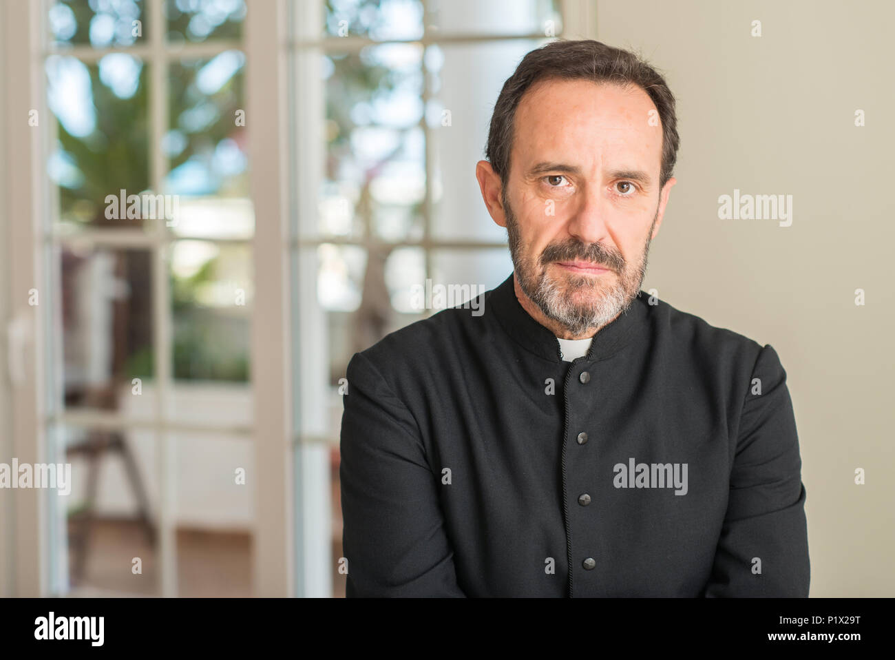 Christian priest man with a confident expression on smart face thinking ...