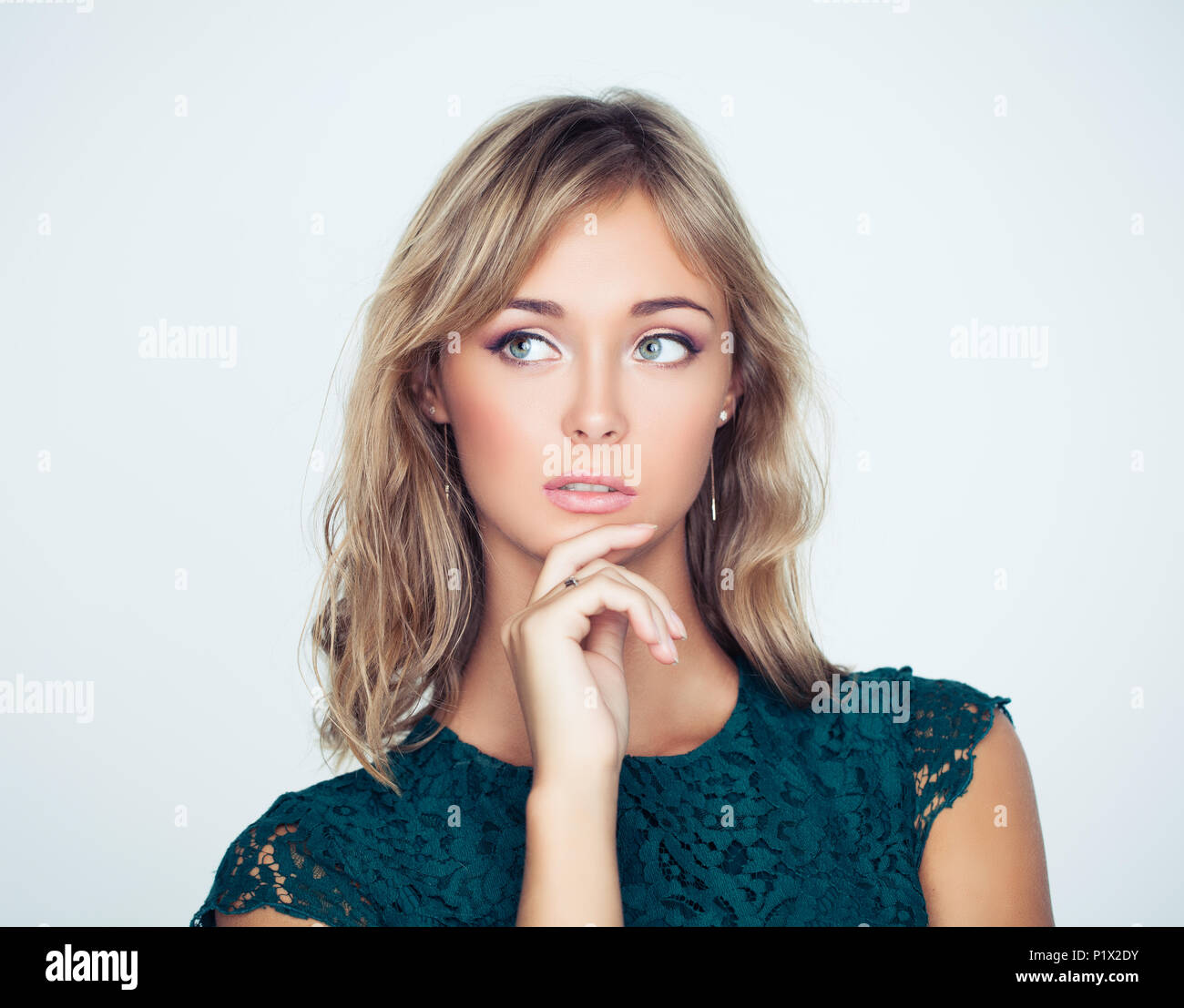 Thinking woman with her hand at her face Stock Photo - Alamy