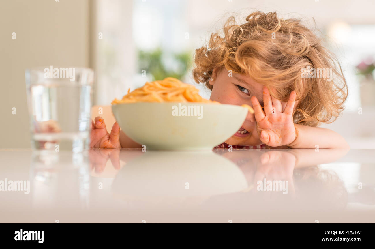 Blond girl eating spaghetti tomato hi-res stock photography and images ...
