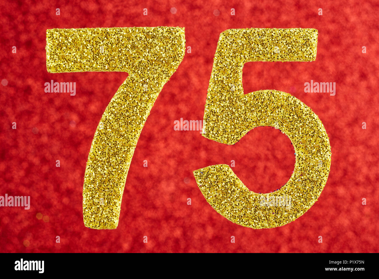 Number seventy-five golden color over a red background. Anniversary ...