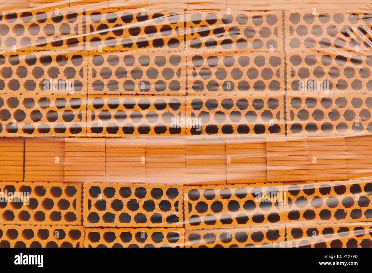 Packed new construction orange bricks. Construction materials ...