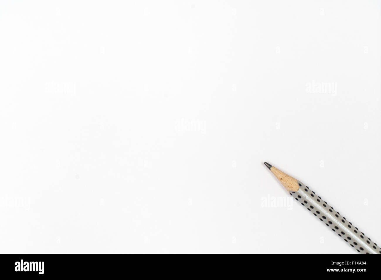 a pencil on a sheet of white paper Stock Photo - Alamy