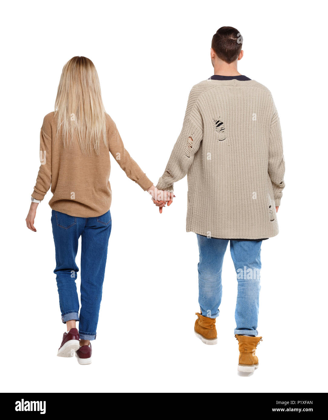 Back view of going couple. walking friendly girl and guy holding hands ...