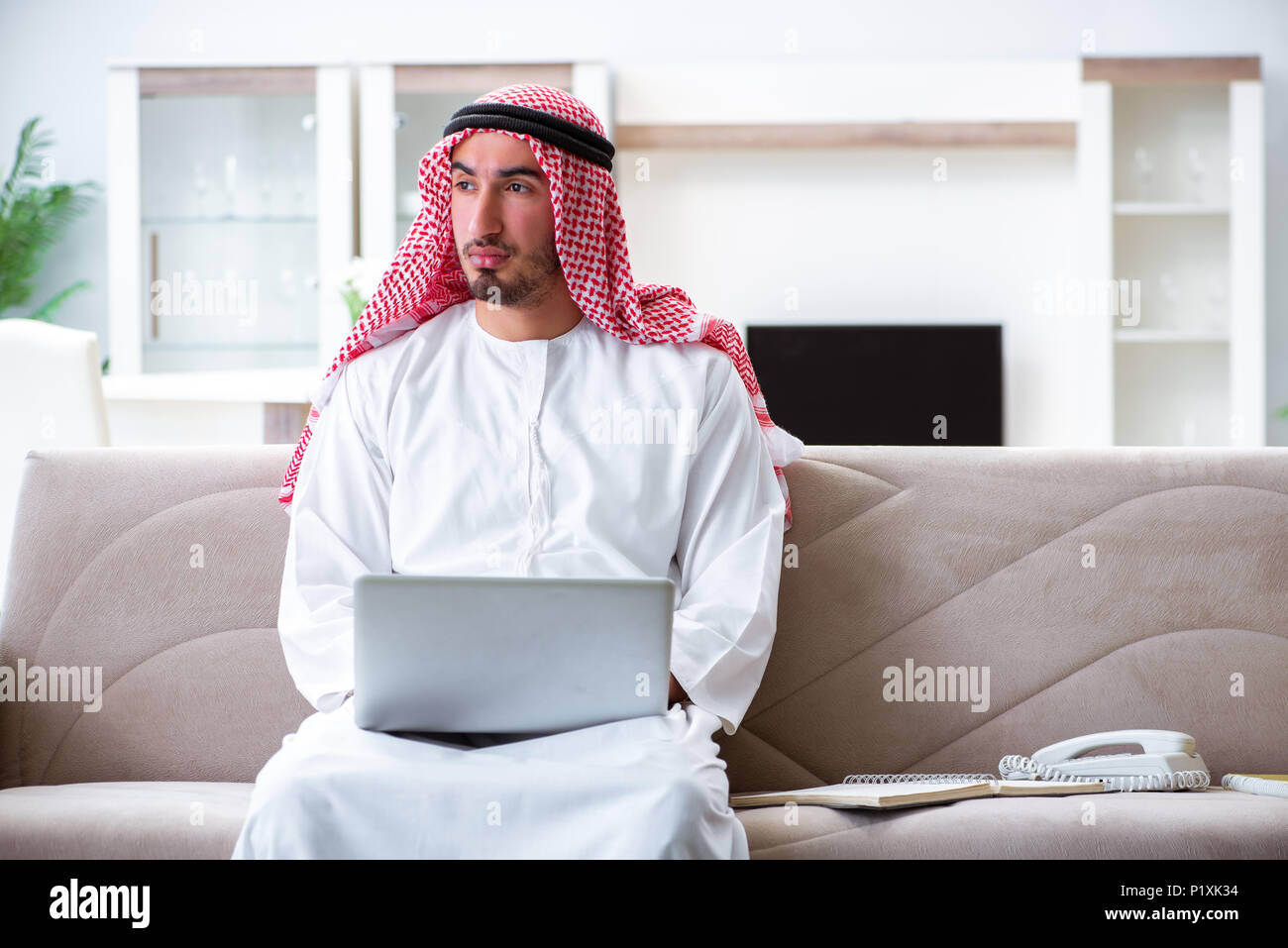Arab man working at home on his work Stock Photo - Alamy