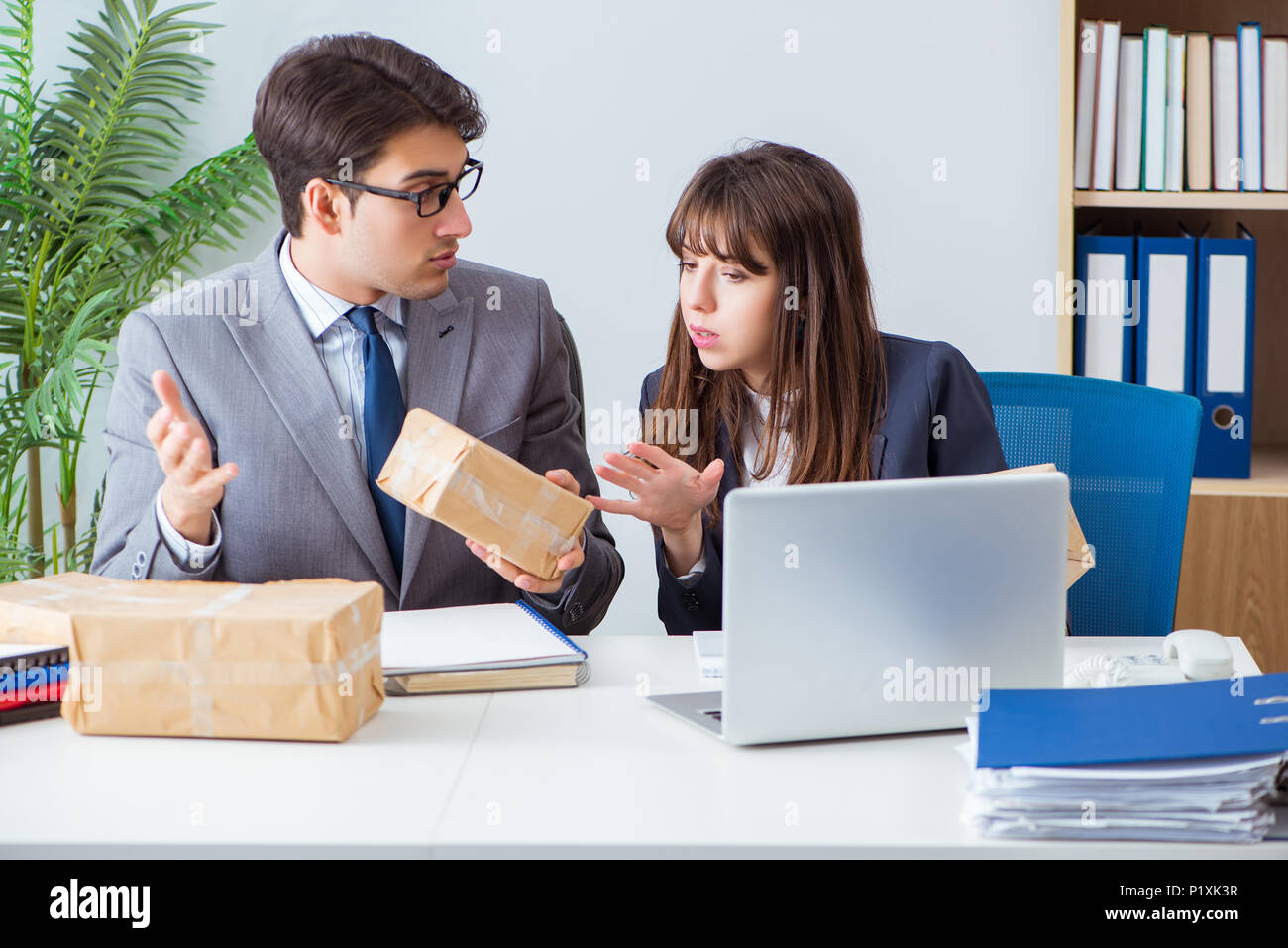 Business people receiving new mail and parcels Stock Photo - Alamy