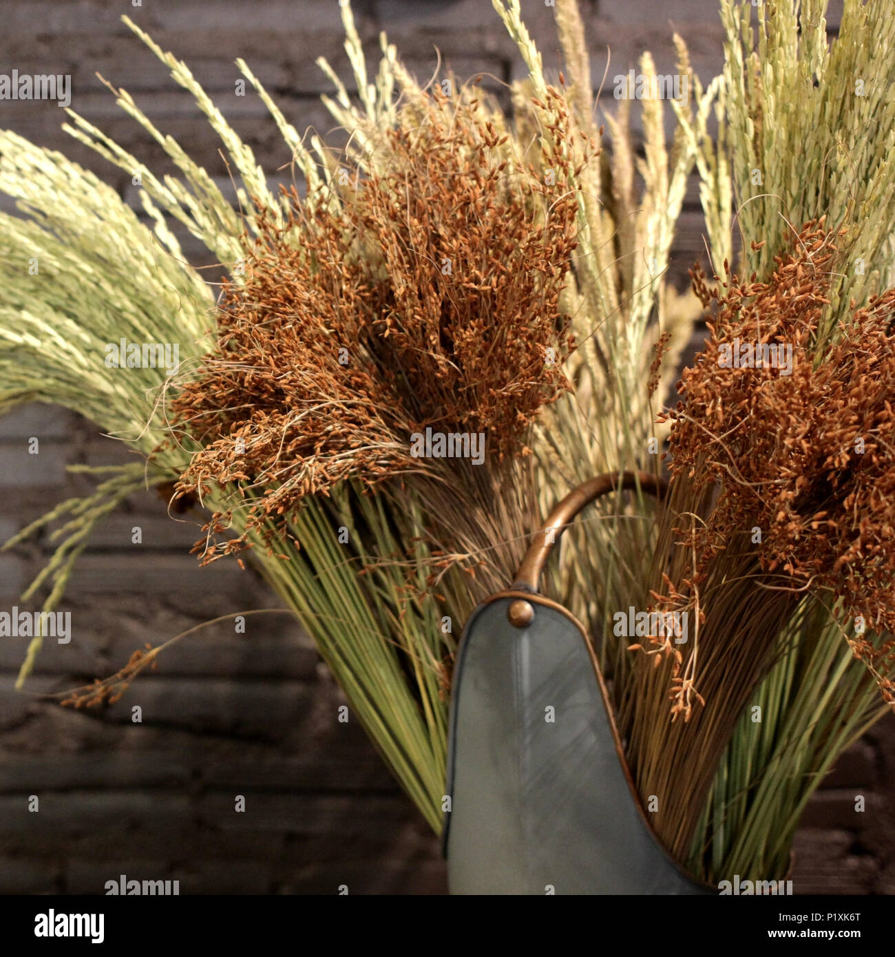 dry flowers and dry rice bouquet in flowerpot with brick wall ...