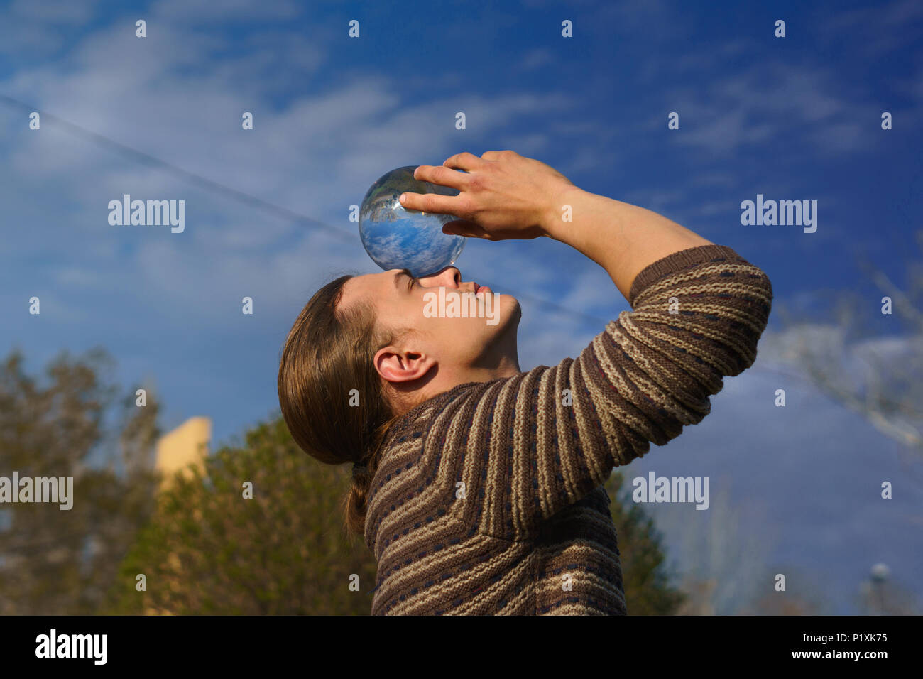 Contact juggling. A man balances a ball on his head. Performance on the ...