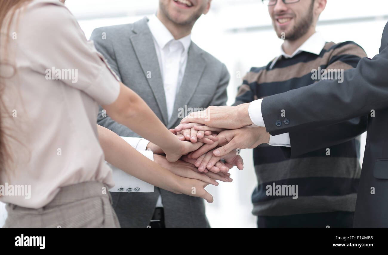 Business team standing joining hands together Stock Photo - Alamy