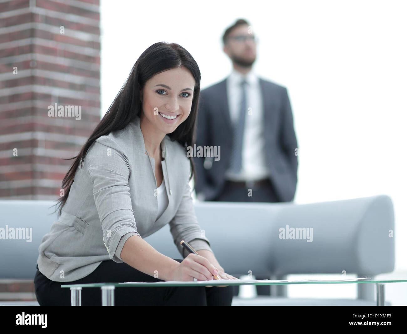 business woman signs documents in a modern office Stock Photo - Alamy