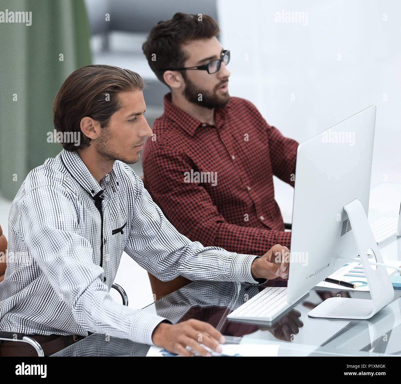 Two employees , sitting in front of computer Stock Photo - Alamy