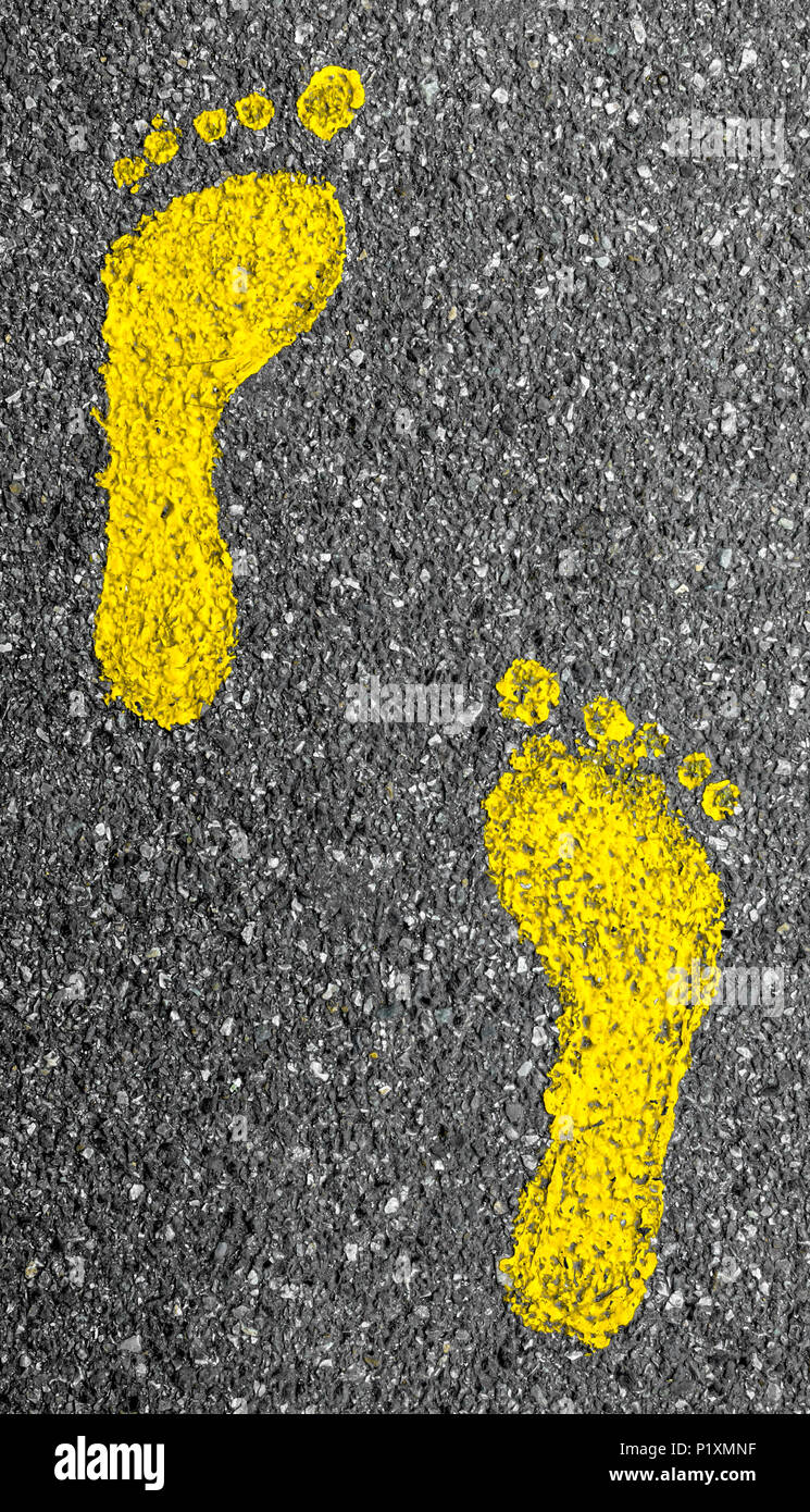 Footprints yellow feet, on a rough asphalt Stock Photo - Alamy
