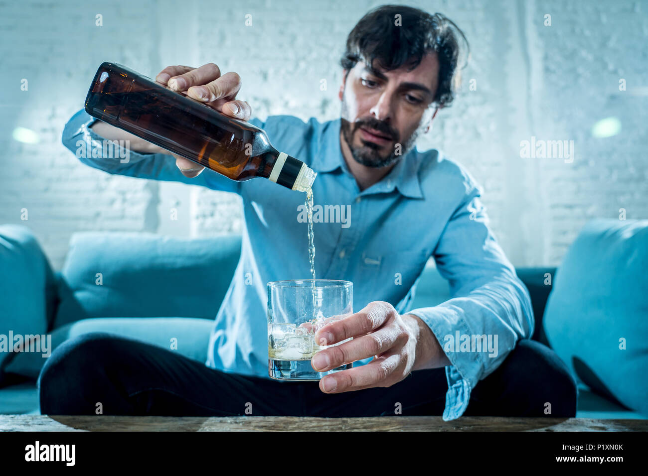 drunk alcoholic lain business man drinking whiskey from the bottle and ...