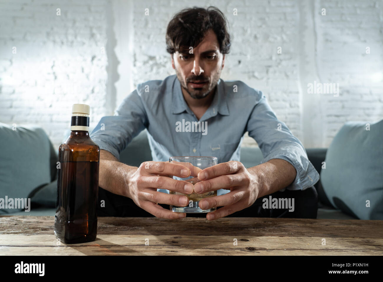 drunk alcoholic lain business man drinking whiskey from the bottle and ...