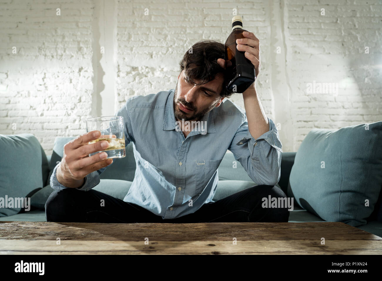 drunk alcoholic lain business man drinking whiskey from the bottle and ...