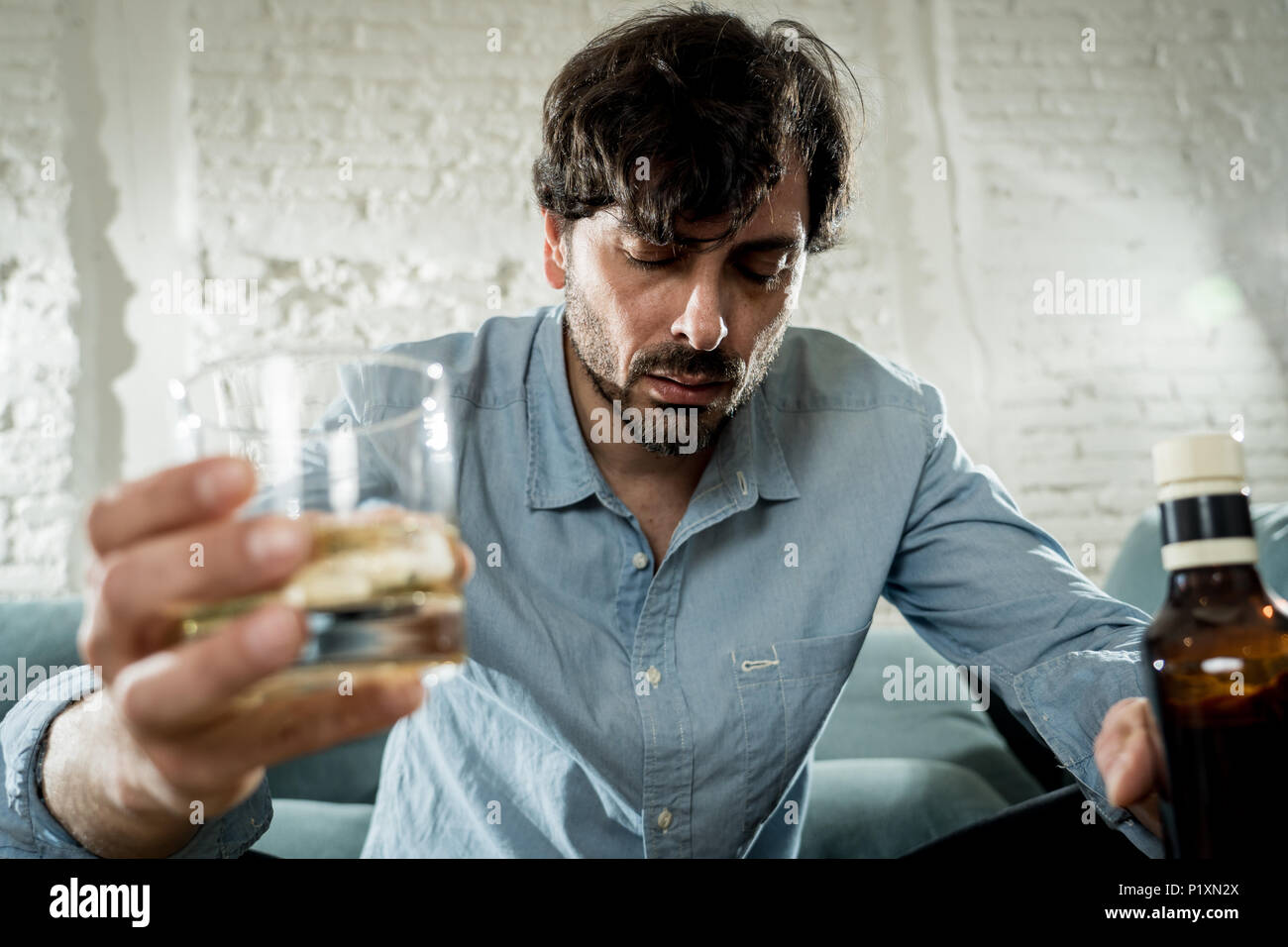 drunk alcoholic lain business man drinking whiskey from the bottle and ...