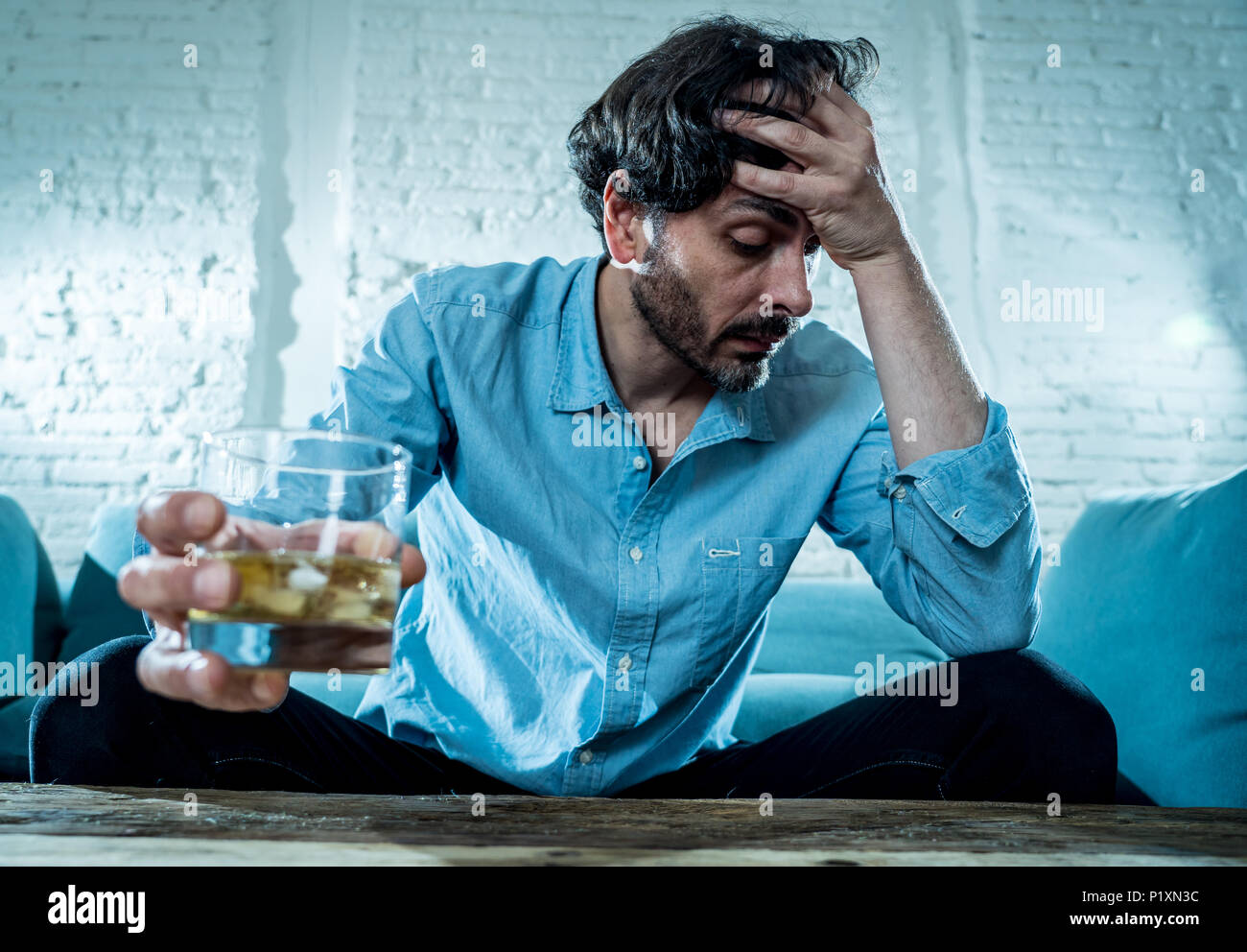 drunk alcoholic lain business man drinking whiskey from the bottle and ...