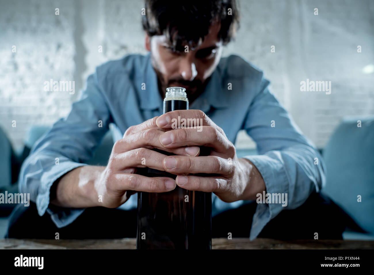 drunk alcoholic lain business man drinking whiskey from the bottle and ...