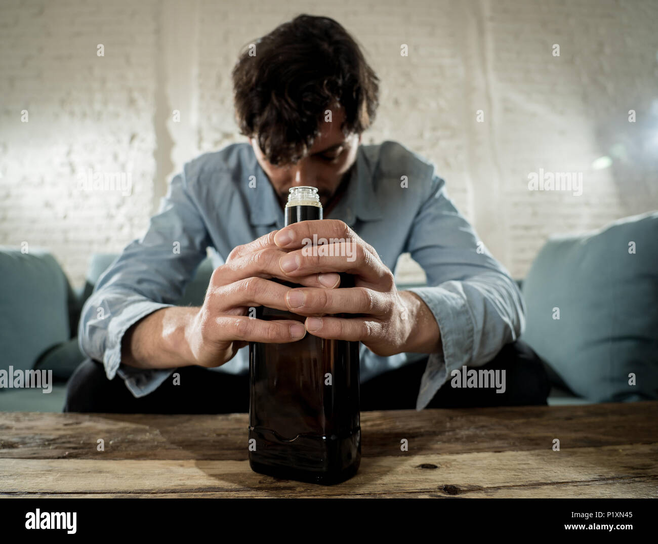 drunk alcoholic lain business man drinking whiskey from the bottle and ...