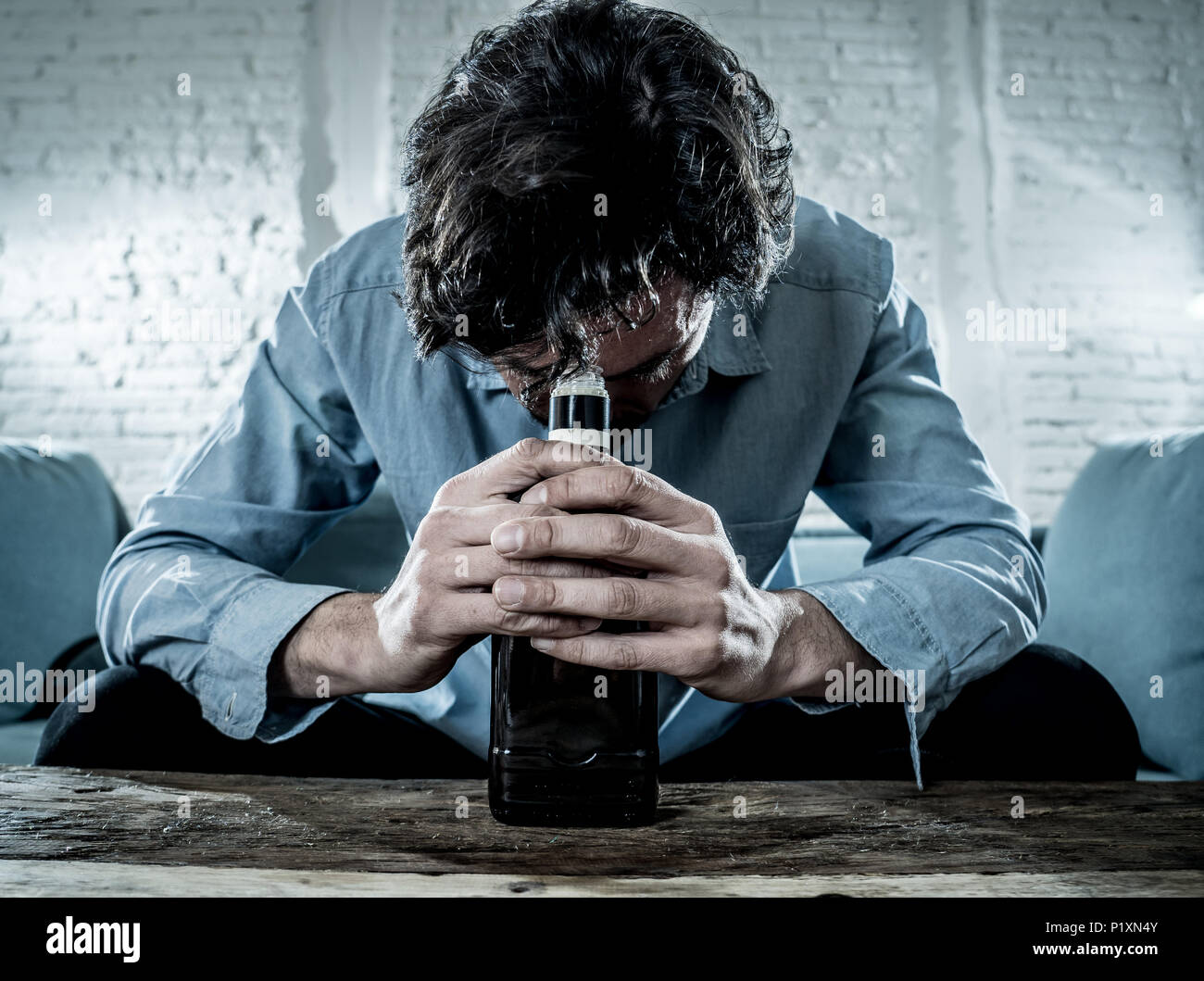 drunk alcoholic lain business man drinking whiskey from the bottle and ...