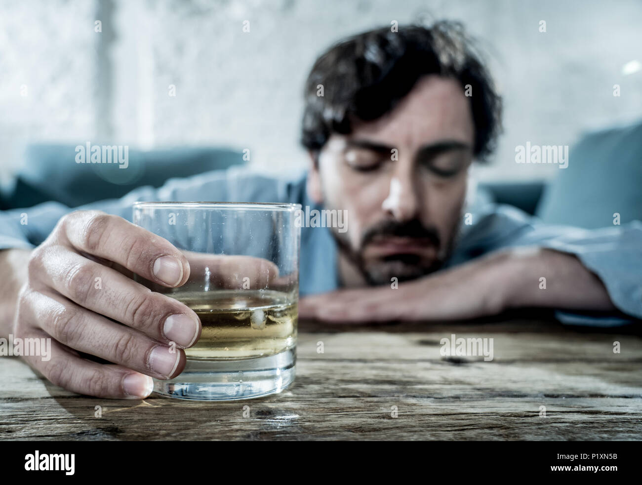 drunk alcoholic lain business man drinking whiskey from the bottle and ...