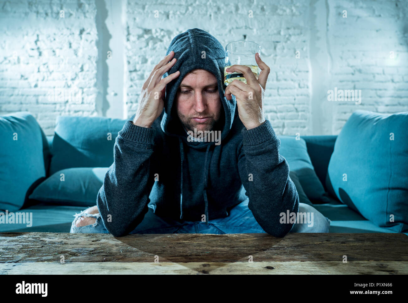 drunk alcoholic unemployed man drinking whiskey from the glass and ...