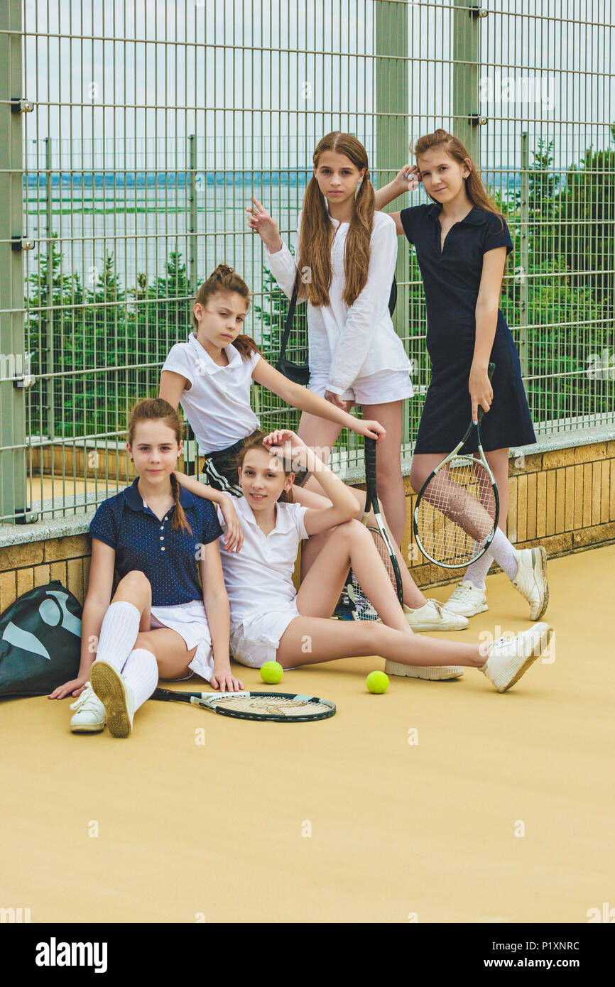 Portrait of group of girls as tennis players holding tennis racket ...
