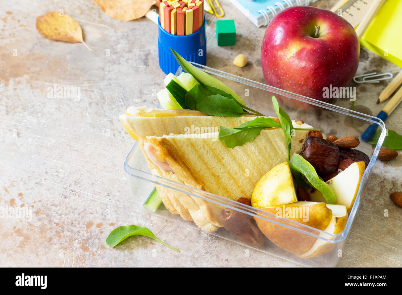 Back to school background. School lunch box, apple and school supplies ...
