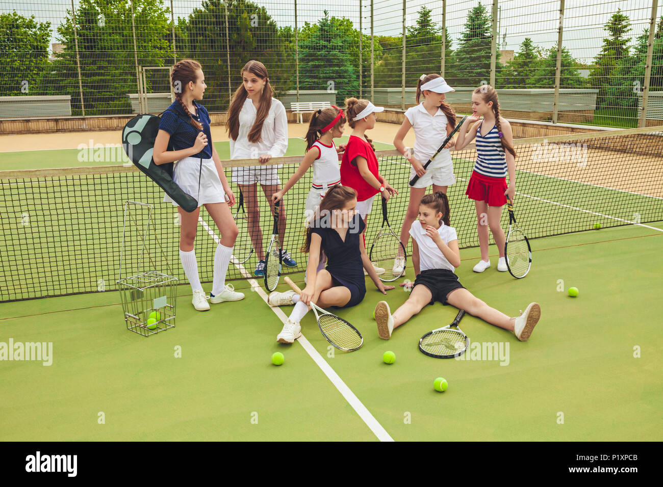 Portrait of group of girls as tennis players holding tennis racket ...
