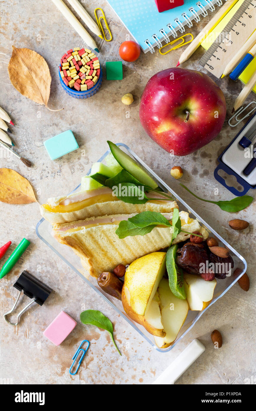 Back to school background. School lunch box, apple and school supplies ...