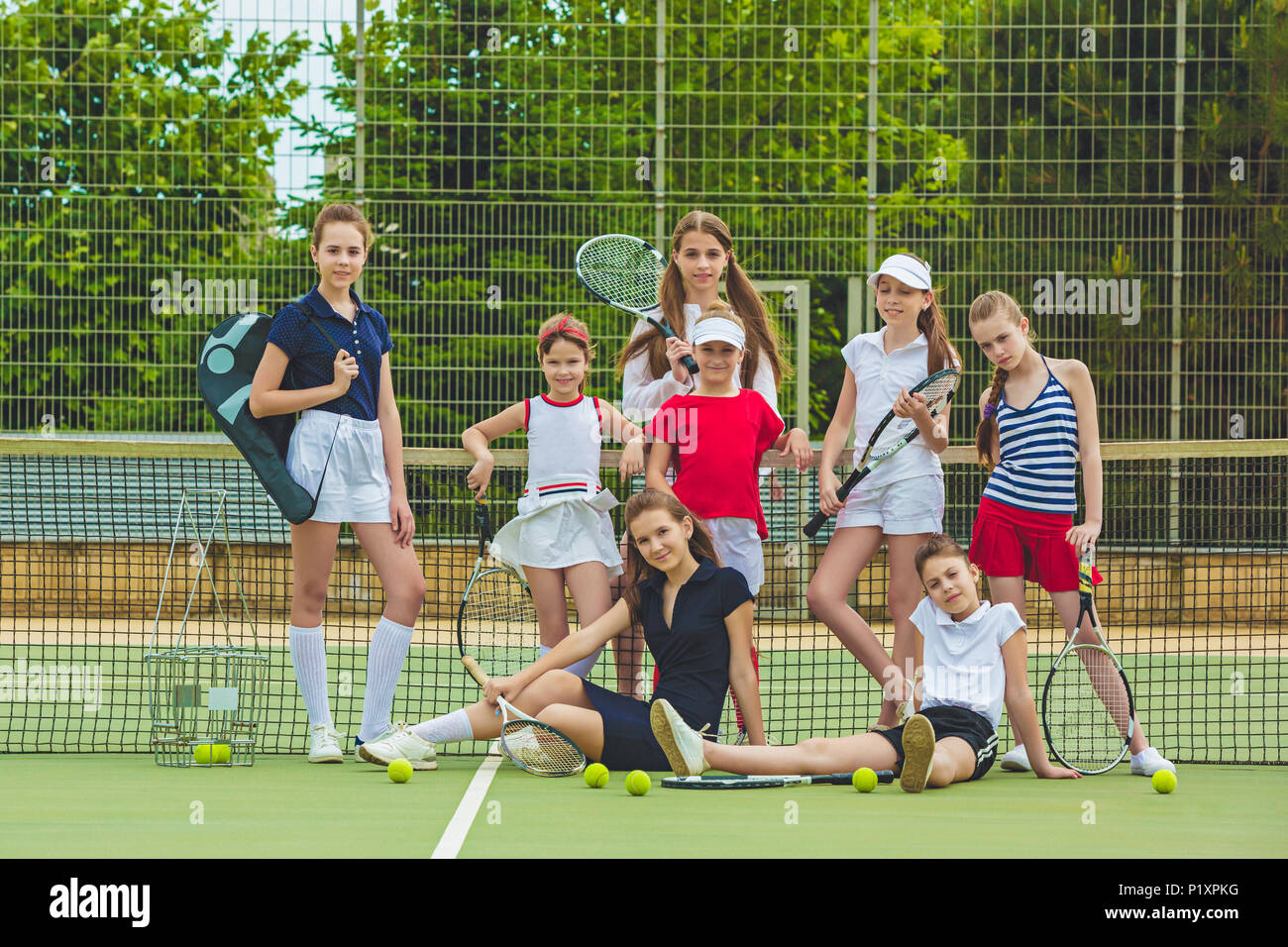 Portrait of group of girls as tennis players holding tennis racket ...