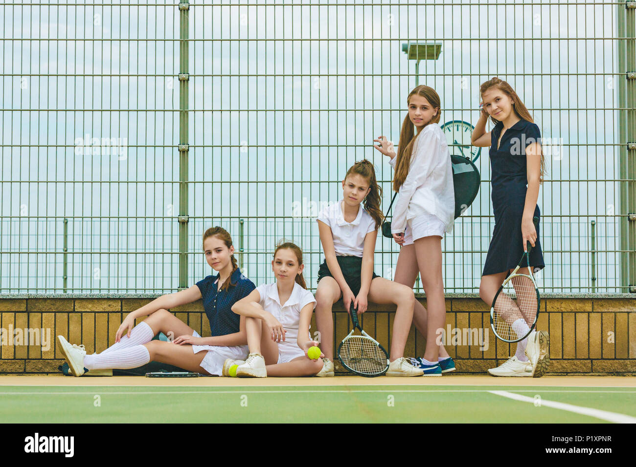 Portrait of group of girls as tennis players holding tennis racket ...