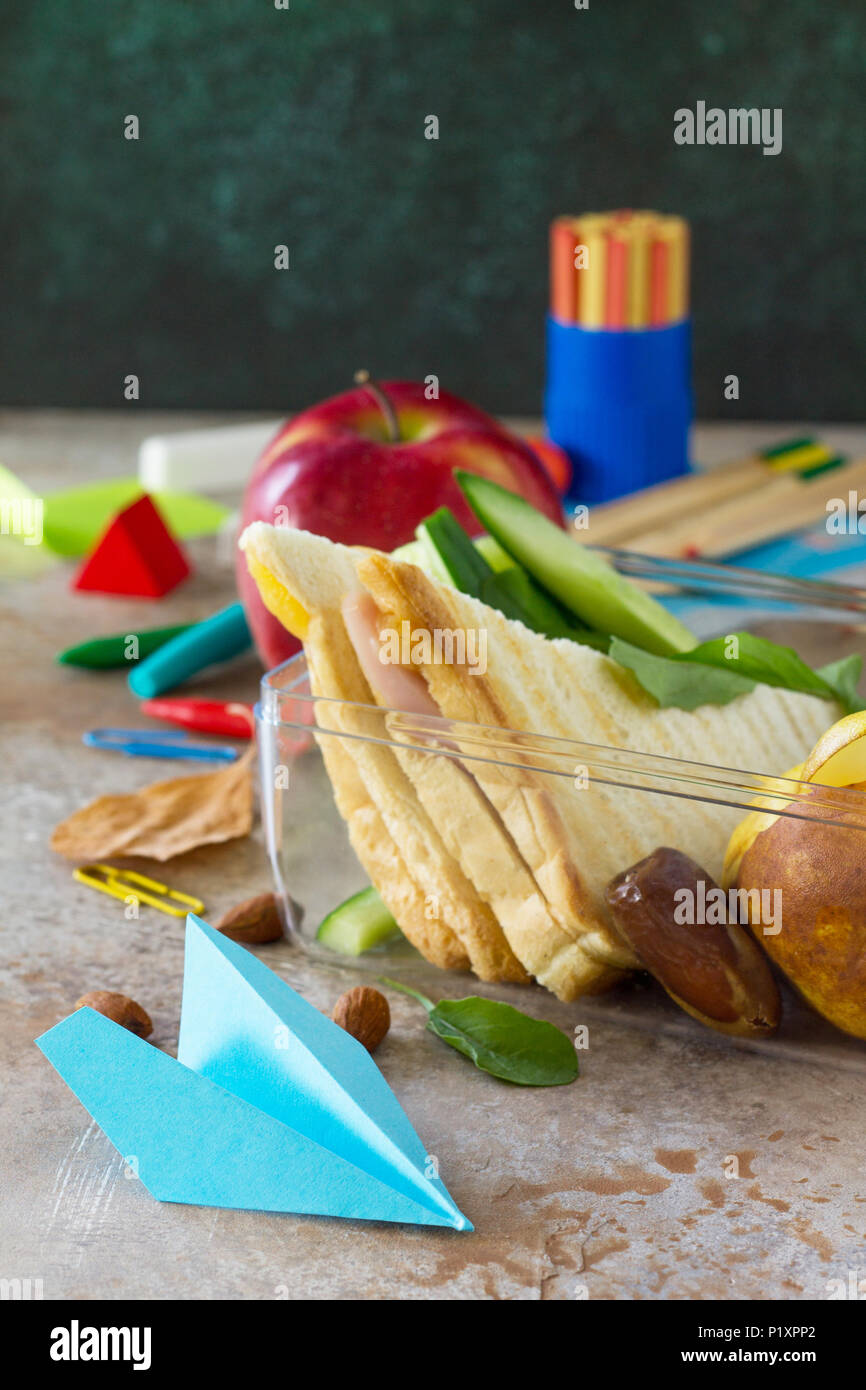 Back to school background. School lunch box, apple and school supplies ...