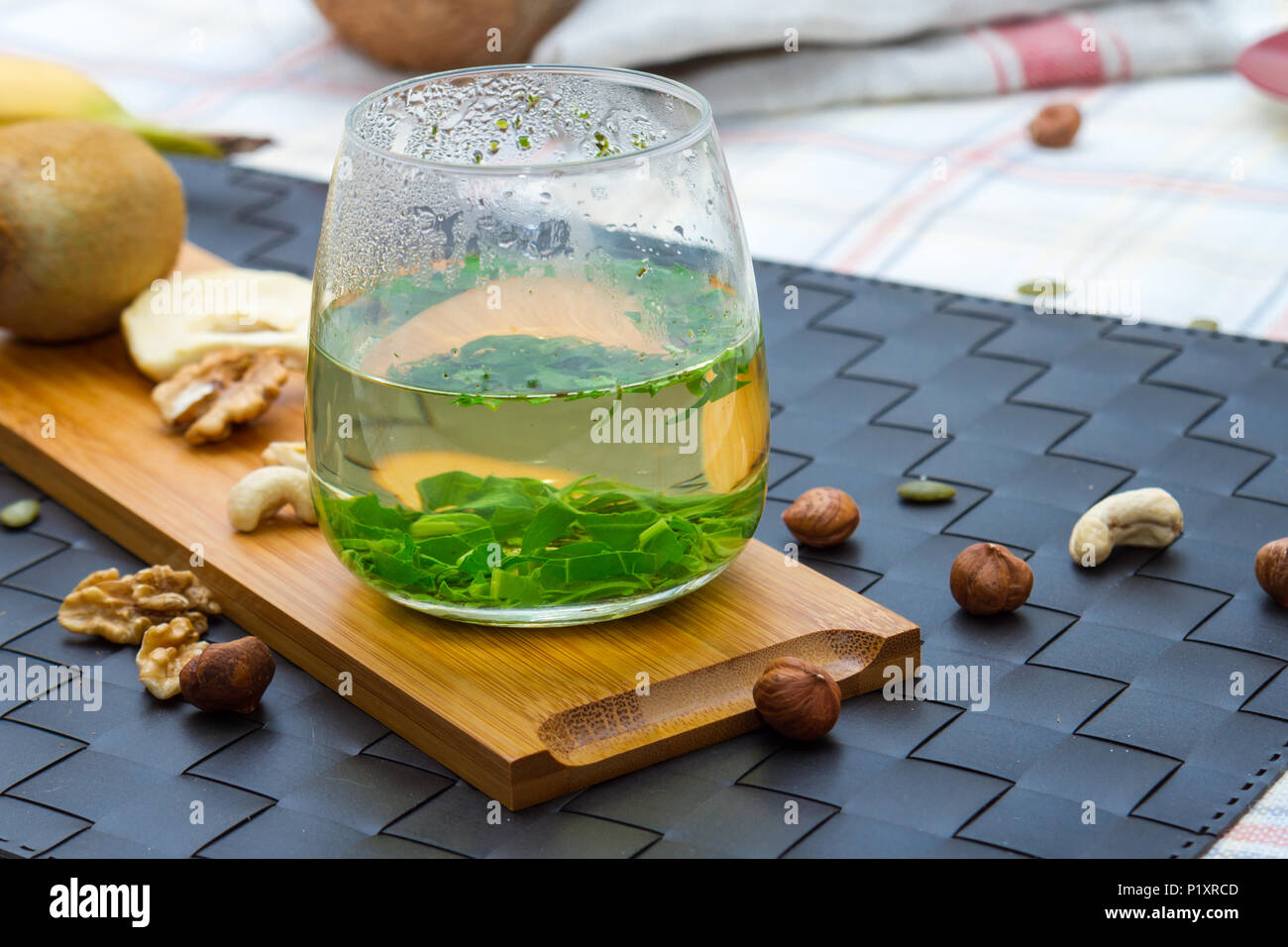 Healthy snack eating and drinking concept with green tea and mix of ...
