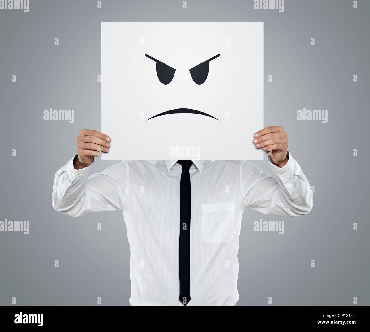 Man with angry emoticon over face Stock Photo - Alamy