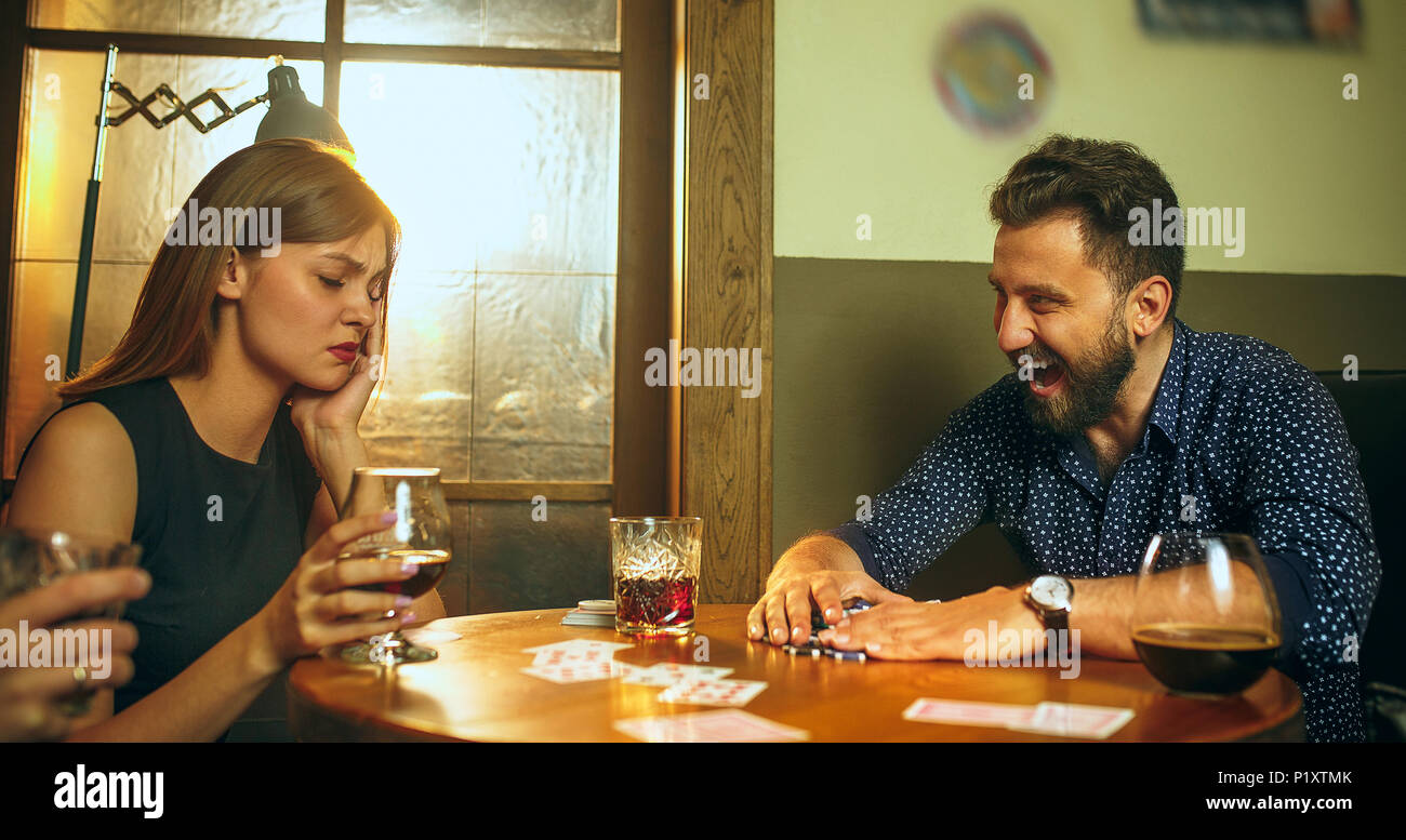 Friends sitting at wooden table. Friends having fun while playing board ...